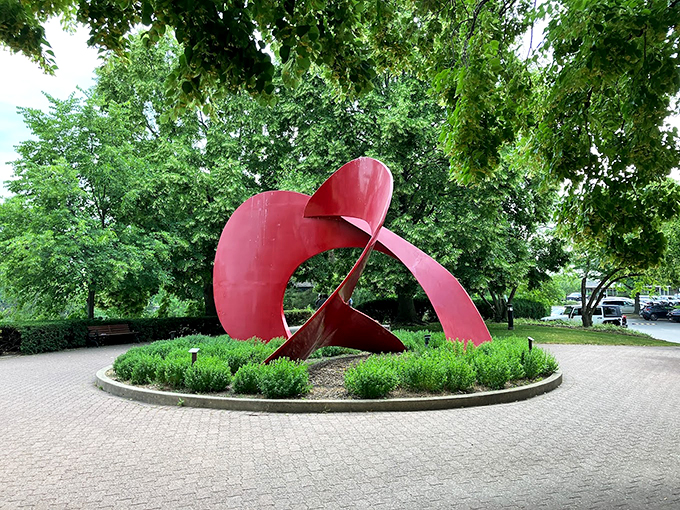 Art meets nature in this bold red sculpture. It's like autumn decided to leave its mark in more than just leaves.