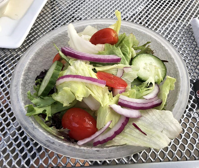Even the salad gets respect here, fresh and crisp enough to make you feel virtuous before diving back into the meat.