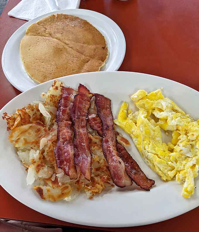 Bacon, hash browns, eggs, and a pancake the size of your head: this plate doesn't mess around with portion control.