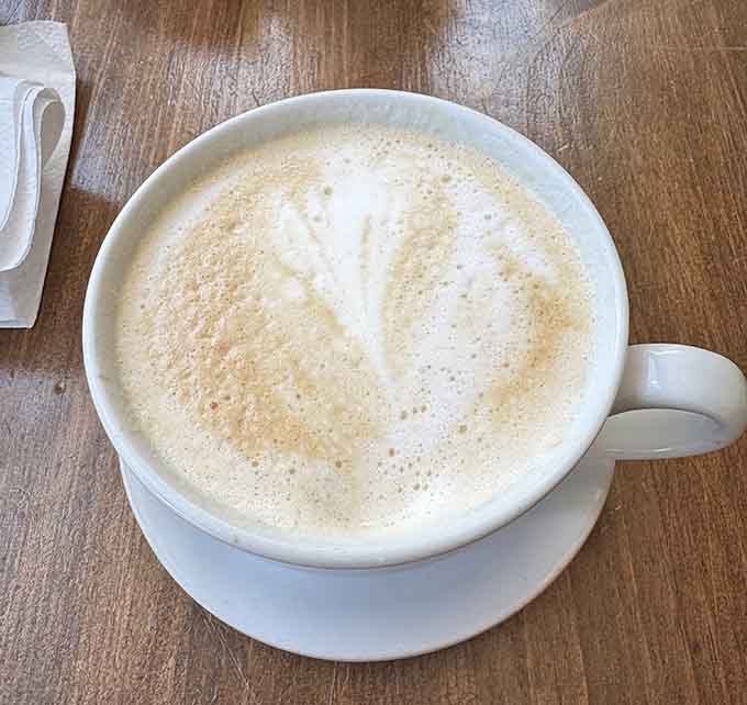 A proper latte with perfectly steamed milk provides the caffeinated companion your breakfast sandwich deserves.