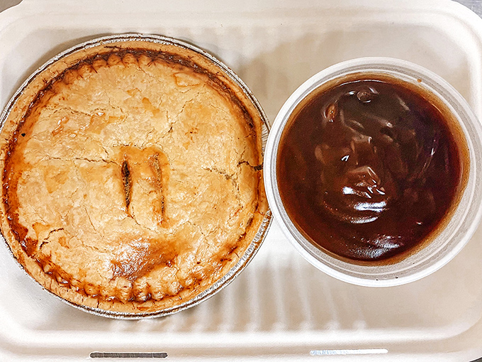 A proper steak pie with its golden-brown crust hiding rich, savory filling &ndash; the kind of hearty fare that's sustained Britons through centuries of damp weather.