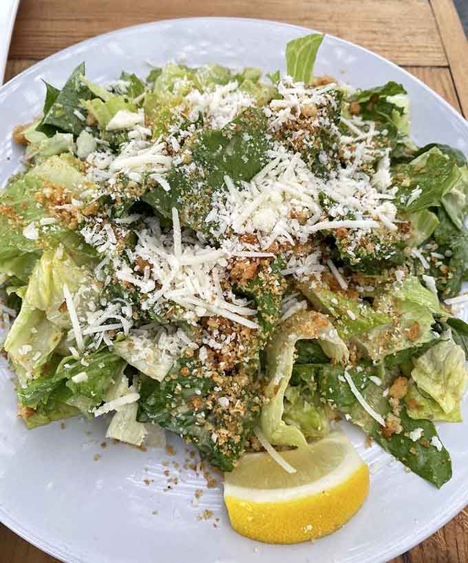 Caesar salad done right with crisp romaine, generous cheese, and enough garlic to make vampires reconsider their career choices.