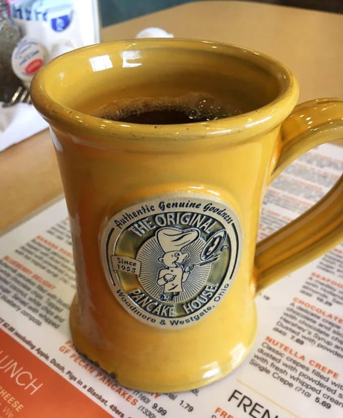 Coffee served in a proper mug with the restaurant's logo, because great pancakes deserve an equally great beverage.