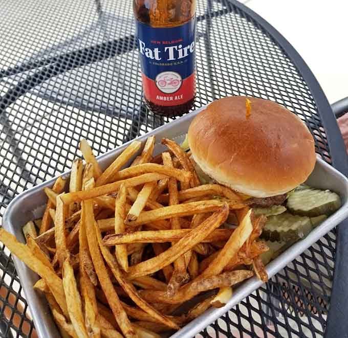 A classic burger with a mountain of crispy fries demonstrates Topper's commitment to perfecting American comfort food favorites.
