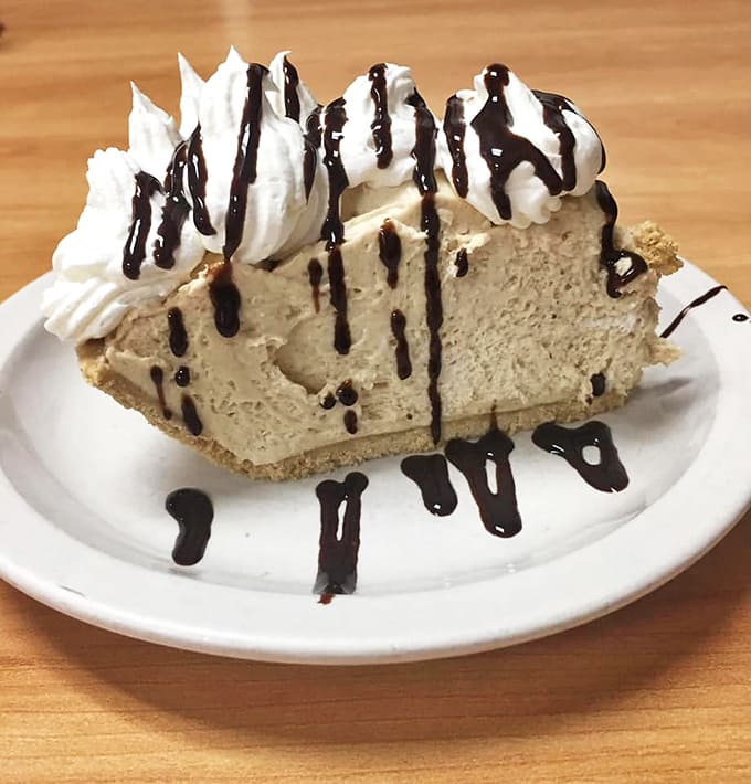 Velvety smooth with a chocolate drizzle crown, this peanut butter masterpiece makes sharing seem like a concept invented by people who've never tasted it.