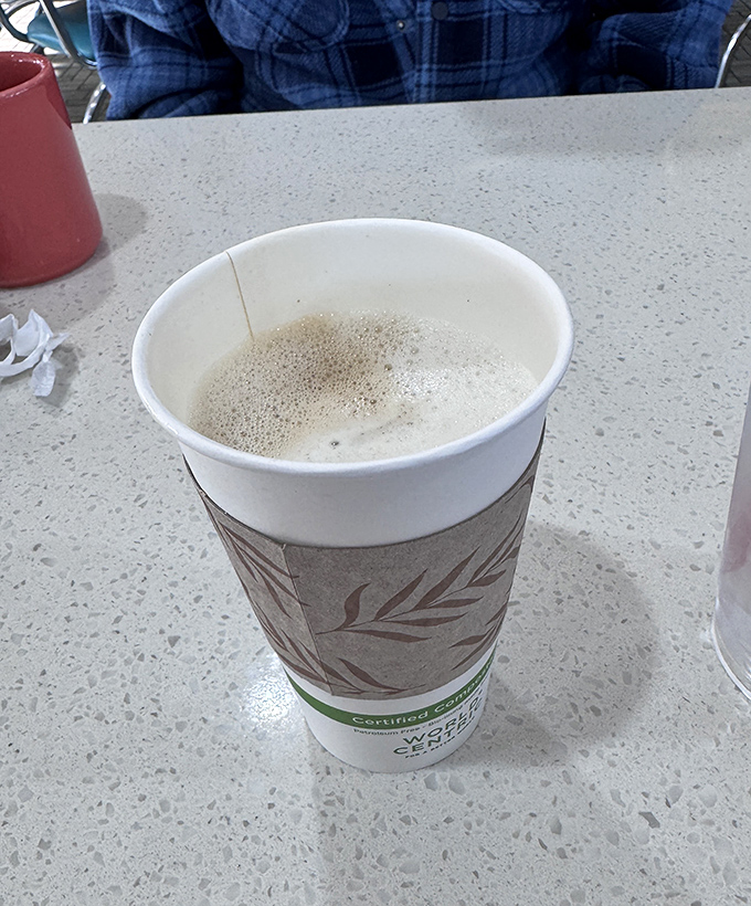 Steam rises from this vanilla latte like morning fog, promising a caffeine embrace that pairs perfectly with any pastry selection.