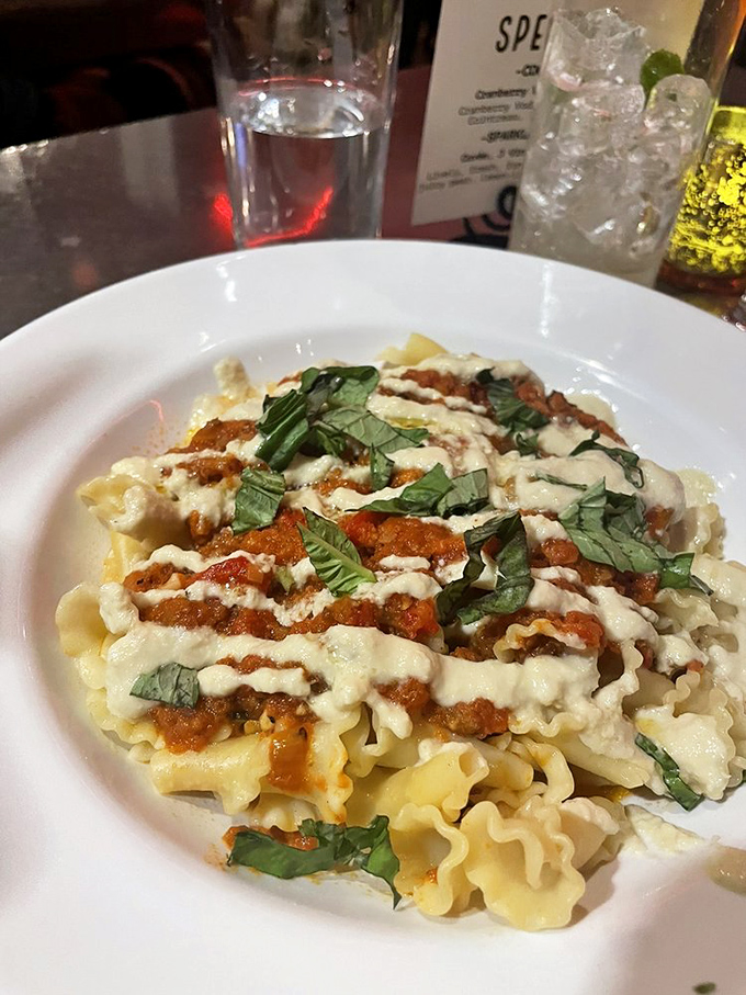 Vegan Bolognese proves plant-based eating doesn't sacrifice richness &ndash; the hearty sauce clings to perfectly cooked pasta, finished with fresh basil's aromatic brightness.