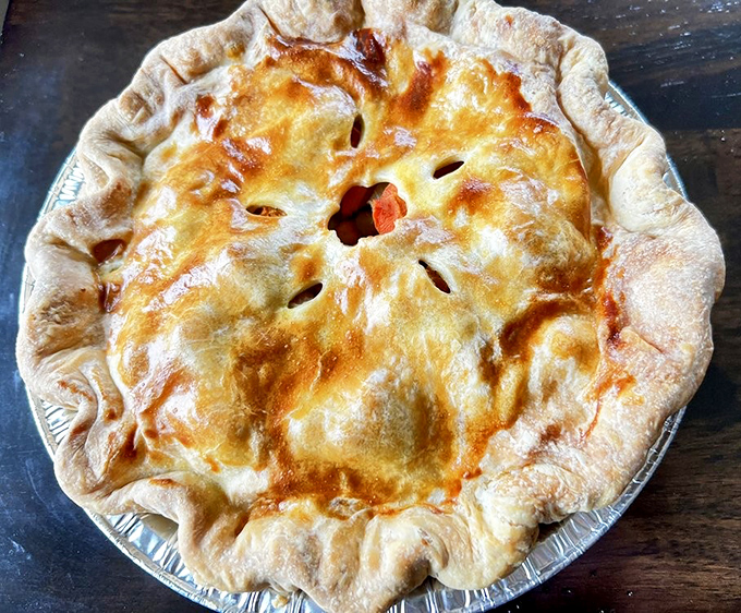 Golden, flaky crust encasing a savory filling that's worth the drive alone. The steam escaping through those vents is practically whispering your name.