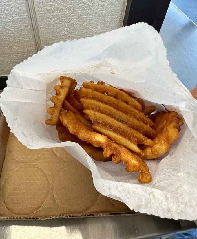 Those waffle fries achieve that perfect balance of crispy exterior and fluffy interior that fry enthusiasts spend lifetimes seeking.