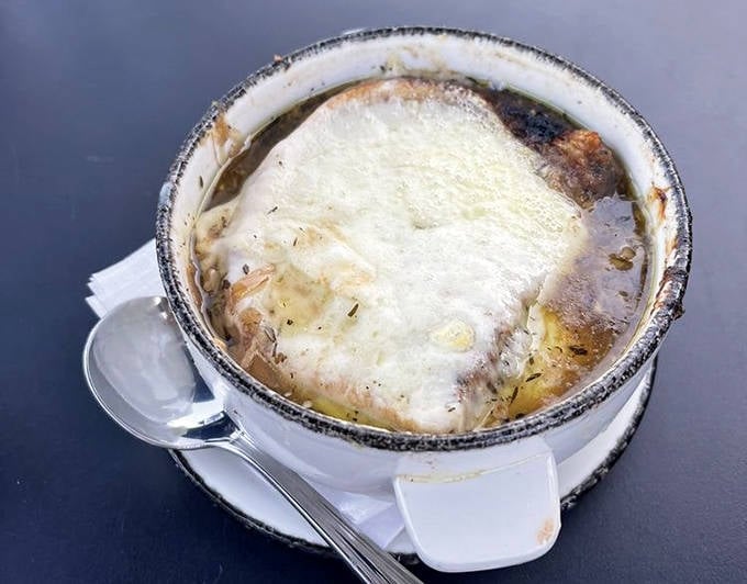 French onion soup worth the wait &ndash; that moment when your spoon breaks through the melted cheese reveals a savory treasure below.