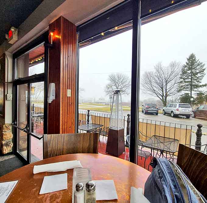 A cozy window table offers the perfect vantage point for people-watching or catching Michigan's dramatic weather shifts while staying warm inside.
