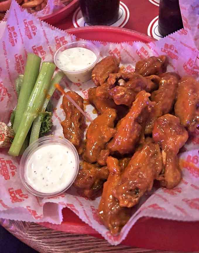 Hot and tangy sauce coats these wings like a delicious glaze, adding vinegary punch to complement the heat while celery sticks stand ready to provide cooling relief.