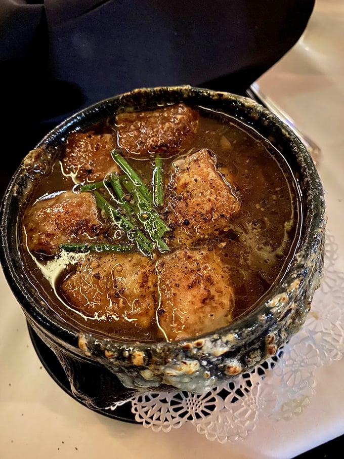 A rustic crock harboring savory secrets &ndash; tender chunks of meat swimming in rich broth that's been simmering to perfection.