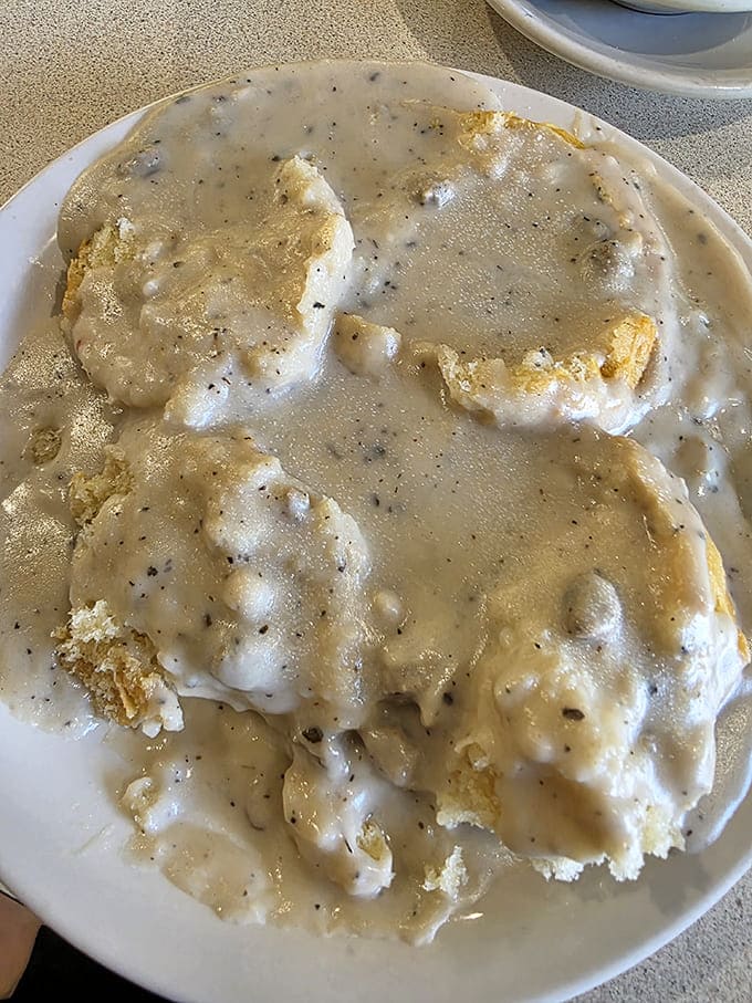 Biscuits drowning happily in peppery sausage gravy &ndash; not a diet food, but certainly a happy food that's worth every delicious calorie.