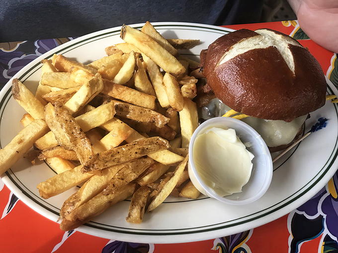 The burger arrives on a pretzel roll with hand-cut fries so good you'll forget ketchup exists &ndash; simple perfection needs no embellishment.