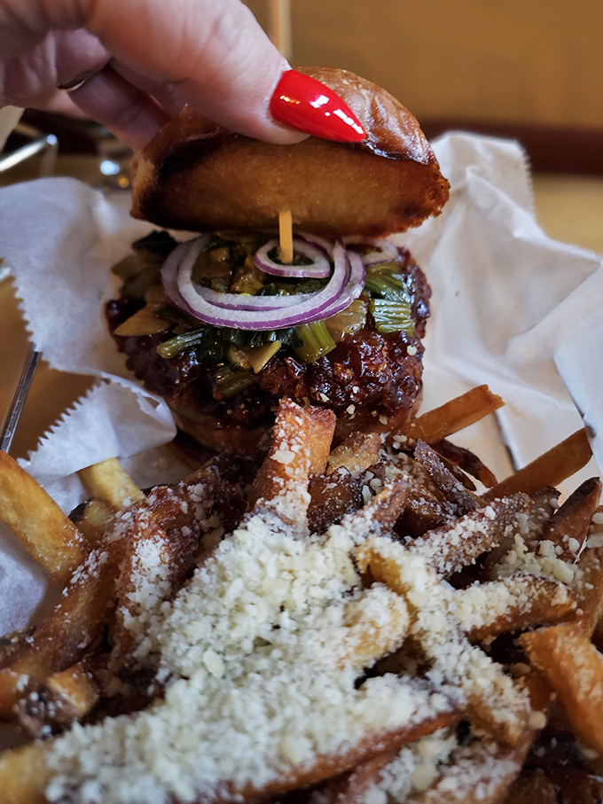 This burger's caramelized onions and melted cheese create a mouthwatering landscape atop the wood-fired patty &ndash; Vermont farm-to-table philosophy in edible form.