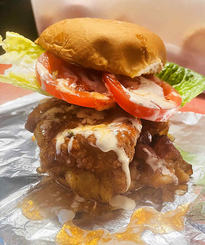 This isn't just a burger – it's a towering seafood masterpiece that requires both hands and several napkins to properly enjoy.