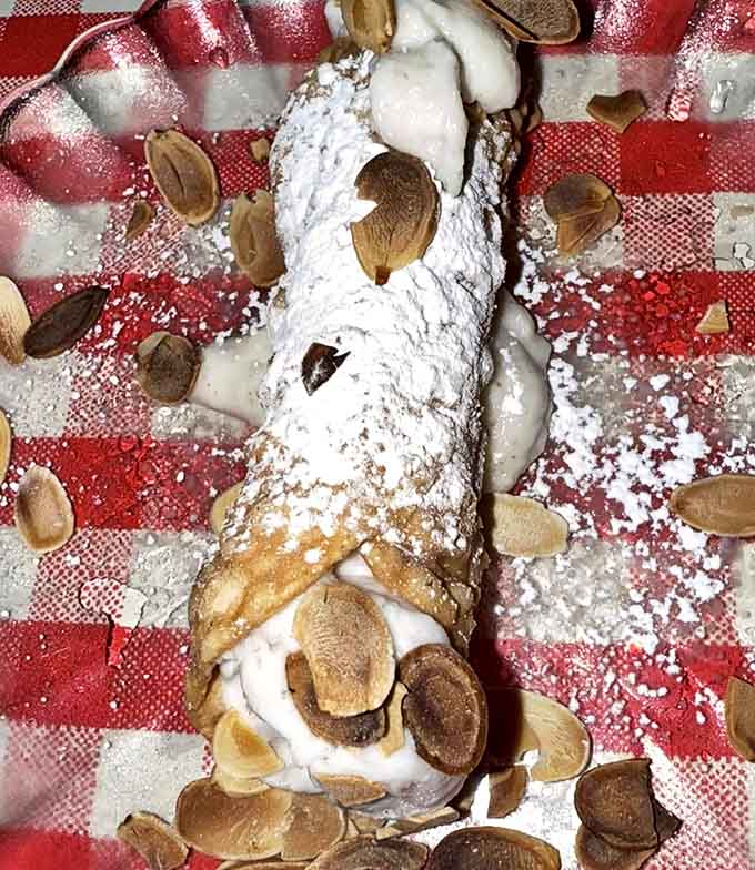 This cannolo isn't just dessert; it's the grand finale &ndash; crisp shell, creamy filling, and almond accents create the perfect sweet ending to your Italian feast.