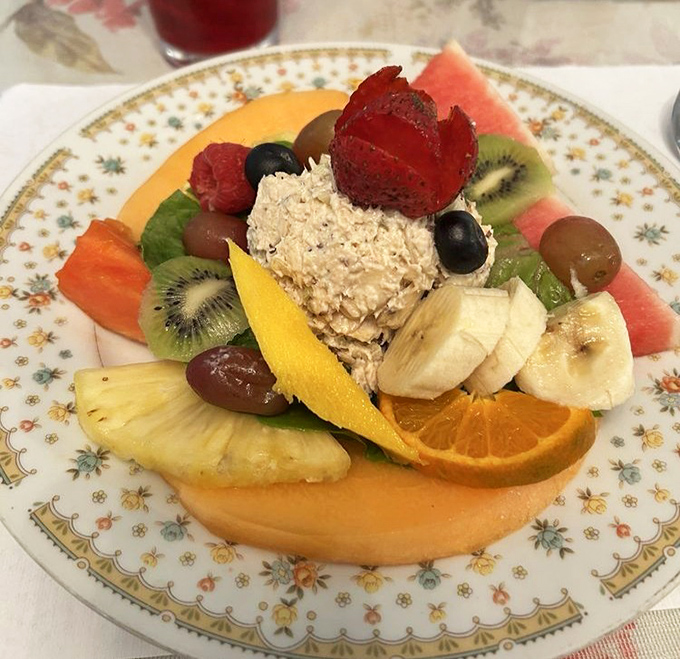 A vibrant plate of freshly prepared chicken salad surrounded by a rainbow of seasonal fruits &ndash; healthy eating never looked so tempting.