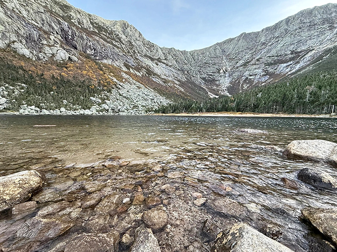 Crystal waters reveal a submerged world of colorful stones and darting shadows, nature's aquarium without the glass barrier.