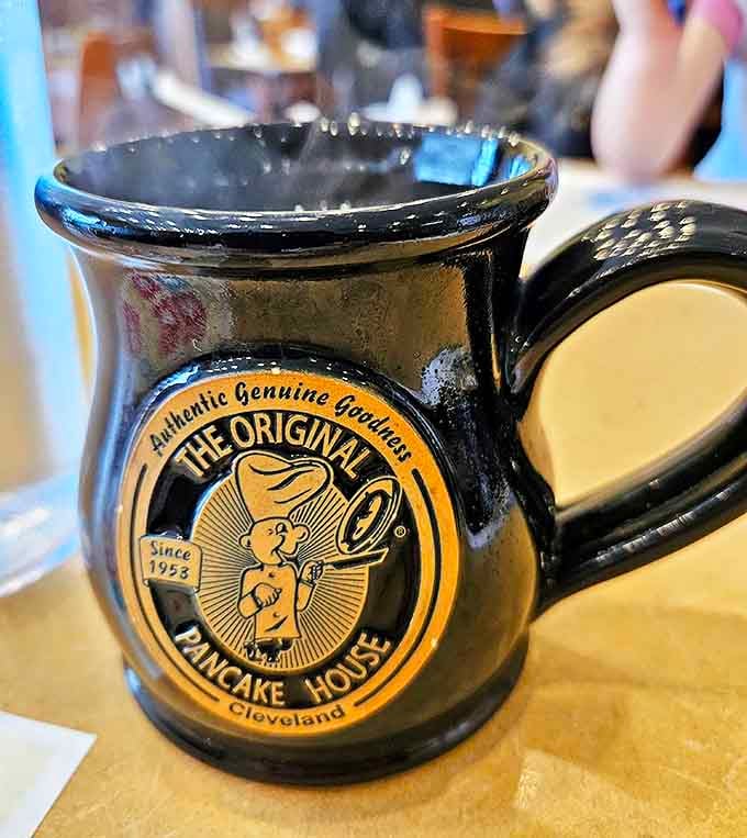 The iconic black mug proudly displays its heritage &ndash; a vessel of caffeinated joy that promises unlimited refills and morning salvation.