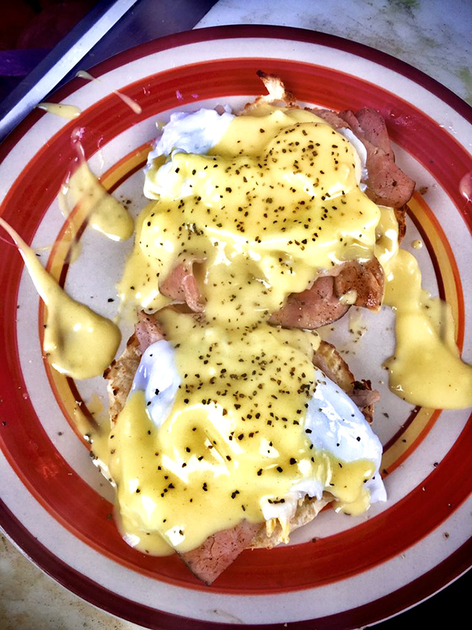 Eggs Benedict done right &ndash; perfectly poached eggs nestled on ham, all blanketed in hollandaise that's worth every delicious calorie.