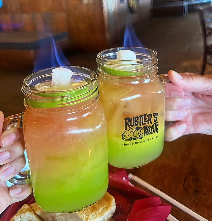 These flaming sunset cocktails aren't just drinks – they're pyrotechnic shows in mason jars that taste as spectacular as they look.