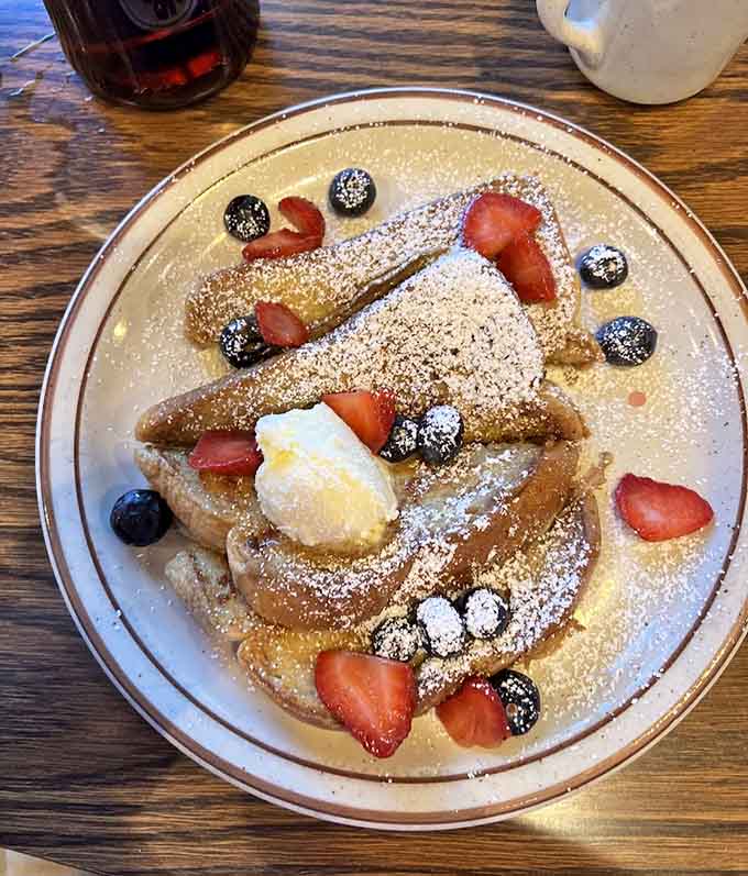 French toast dusted with powdered sugar and fresh berries makes mornings worth waking up for, especially when it's this beautifully prepared.