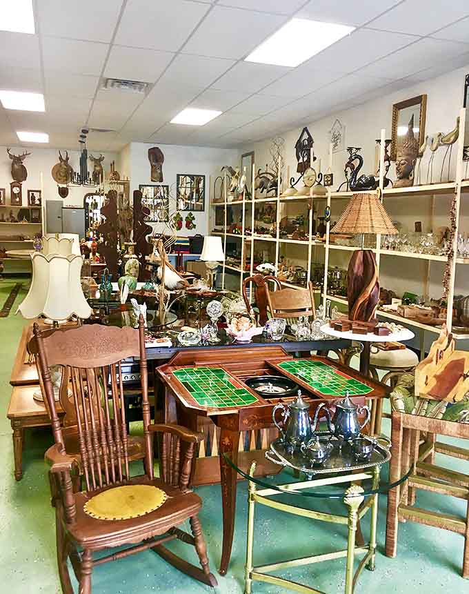 Furniture and lamps arranged like a living room designed by someone who couldn't pick a favorite decade, bless them.