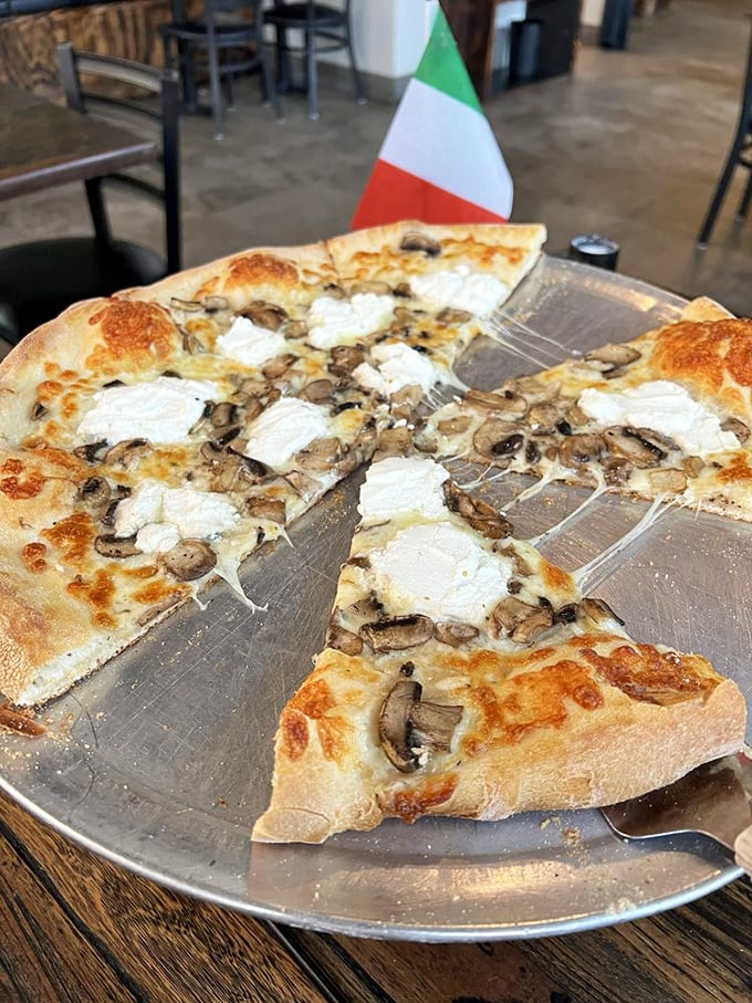 The mushroom and ricotta pizza proudly flies the Italian flag, its perfectly charred crust supporting dollops of creamy cheese and earthy mushrooms.