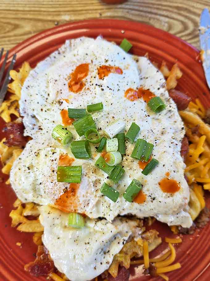 Delicate white clouds hiding sunshine-yellow yolks, perched atop something savory &ndash; breakfast architecture at its finest.