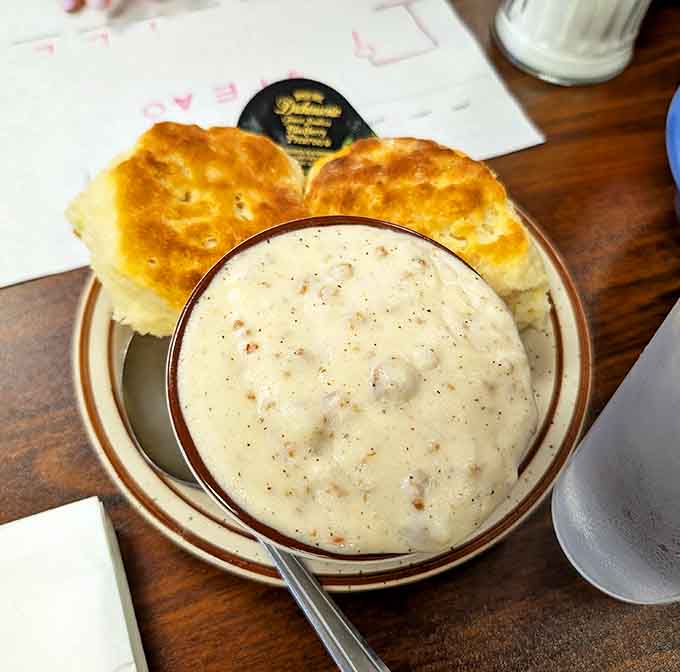Creamy sausage gravy cascading over flaky biscuits: Southern comfort food that found a happy home in Michigan.