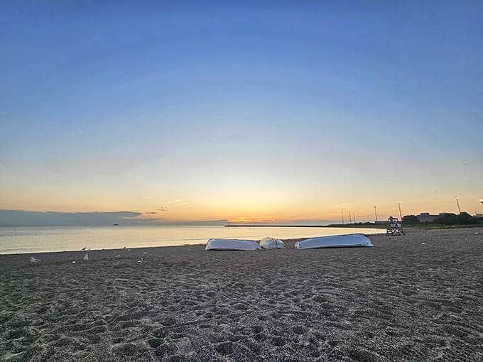 Early morning at Rainbow Beach offers serene moments before the day begins, with boats resting on shore awaiting their next adventure.