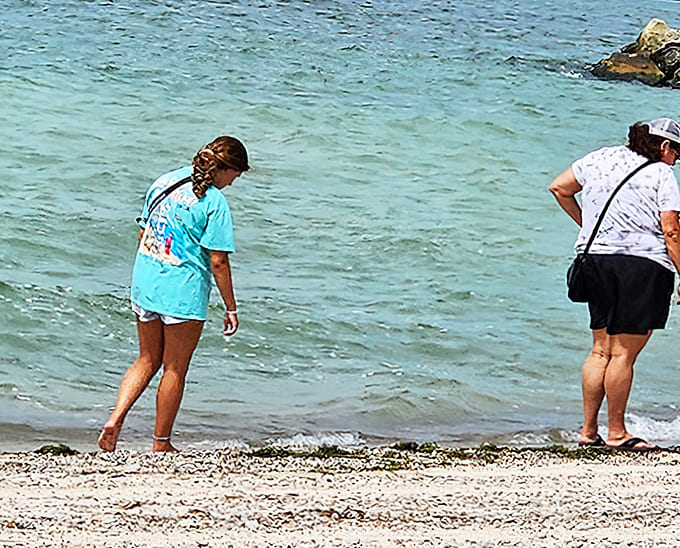 Beach treasure hunters at work. One person's ordinary pebble is another's perfect souvenir &ndash; the hunt is half the fun!