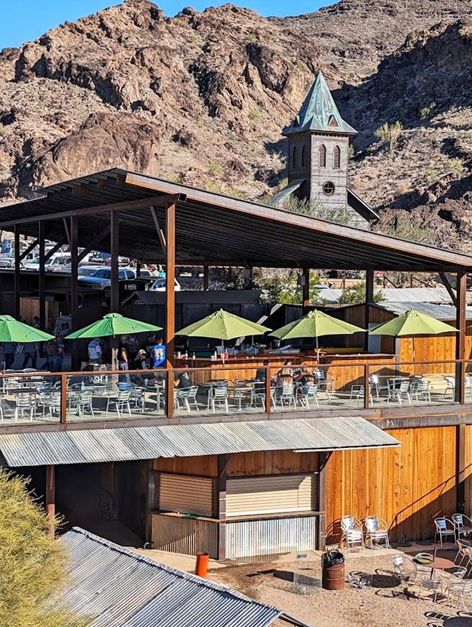 Under a canopy of solar panels and desert sky, patrons bask in the glow of good company and cold drinks.