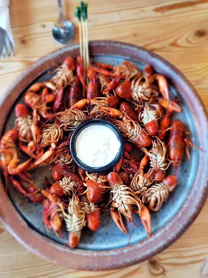 A mountain of crayfish arranged like edible art, complete with dipping sauce, because sometimes the best appetizers require a little hands-on commitment.