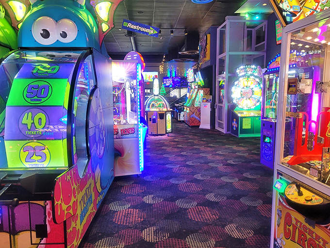 Neon lights create a glowing wonderland of gaming possibilities, each machine promising tickets, thrills, and bragging rights.