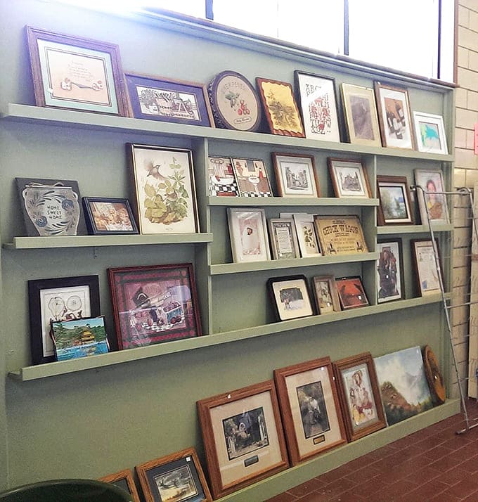 These framed memories and artwork await new walls to grace, each piece carrying stories from homes and hearts now ready to share them.