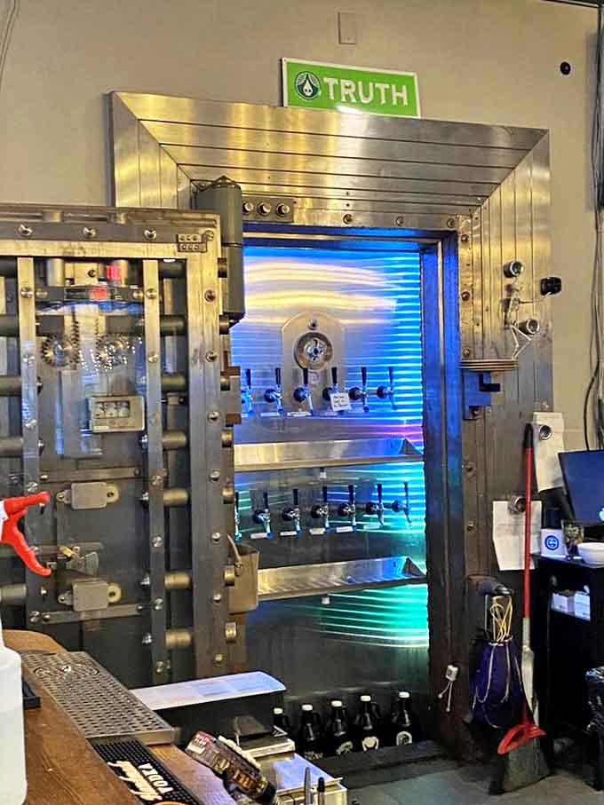 The beer vault &ndash; literally! An old bank vault repurposed as the coolest beer cooler you've ever seen, glowing with blue light like a treasure chest.