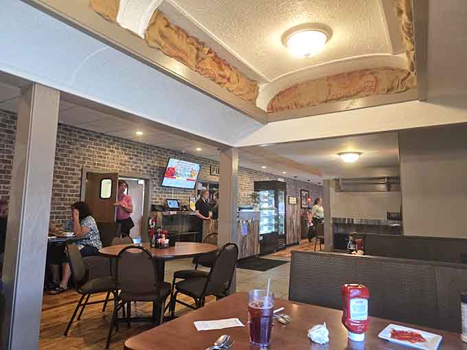 Exposed brick and comfortable booths create an atmosphere where everyone from grandparents to grandkids feels right at home.