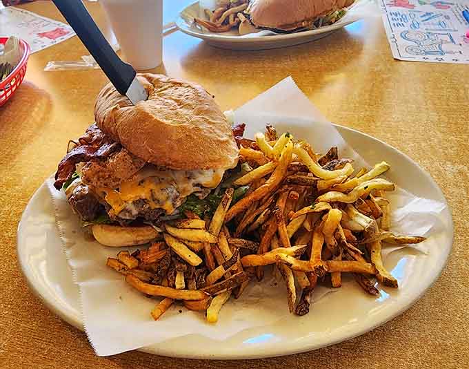 The Duke Burger arrives with a mountain of fries, looking like it means business and tastes like it graduated with honors.