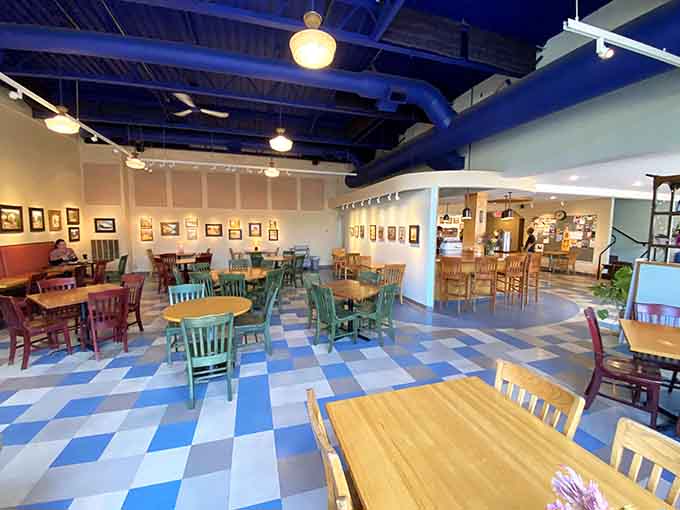 Natural light pours through those big windows, making every table feel like the best seat in the house for your coffee break.