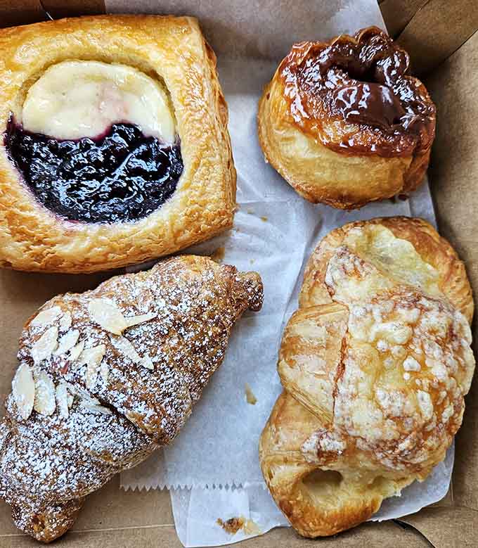 The pastry case lineup looks like the starting roster for Team Delicious in the Breakfast Olympics.