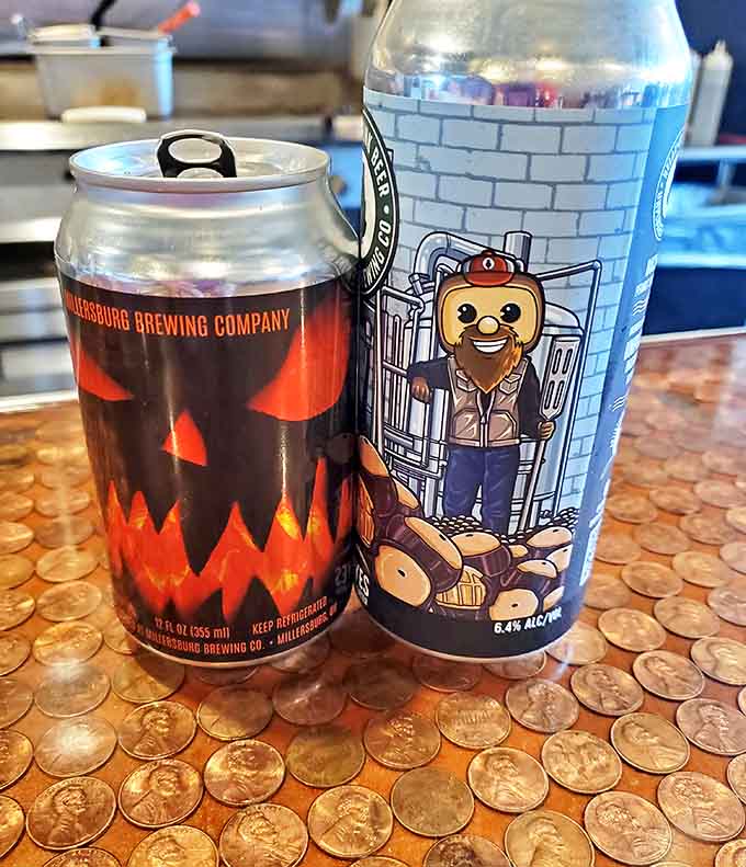 Local brews in eye-catching cans rest on the signature penny countertop, offering the perfect hoppy complement to the bold flavors on your plate.