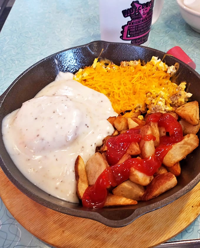 A cast-iron masterpiece of eggs, cheese, potatoes and ketchup-drizzled home fries. Morning glory in sizzling form.