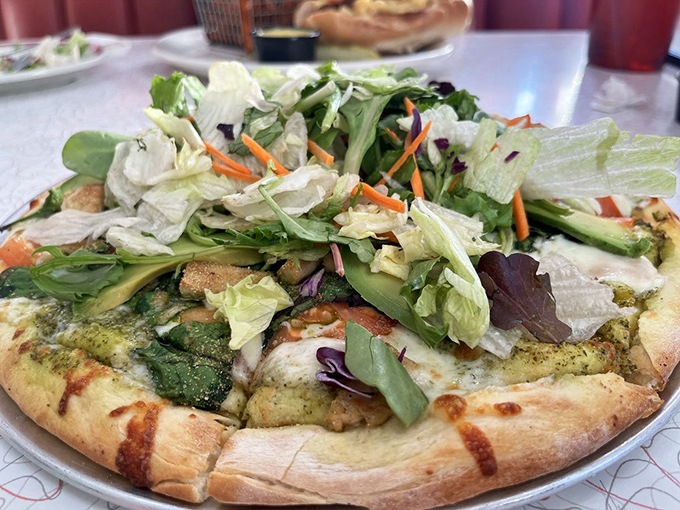 Garden-fresh greens crown a pesto pizza &ndash; proof that diners can do more than just burgers and still make you swoon.