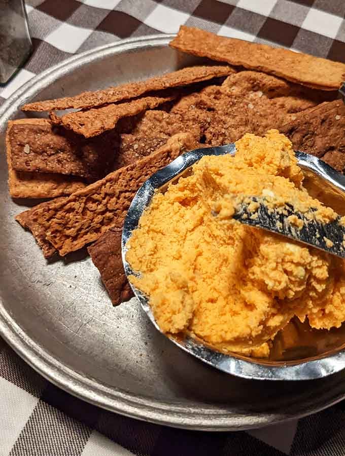 Cheese and crackers arrive like edible architecture, proving appetizers deserve respect too.