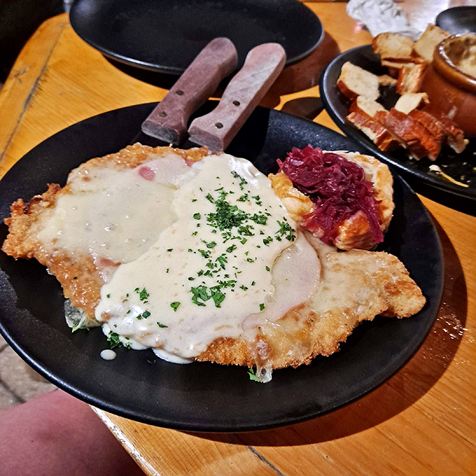 The schnitzel arrives golden and crispy, topped with a velvety sauce that would make any German grandmother nod in approval.