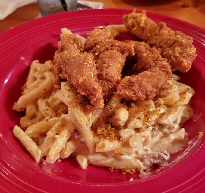 Crispy chicken tenders nestled on creamy mac and cheese &ndash; proof that sometimes more is definitely more.