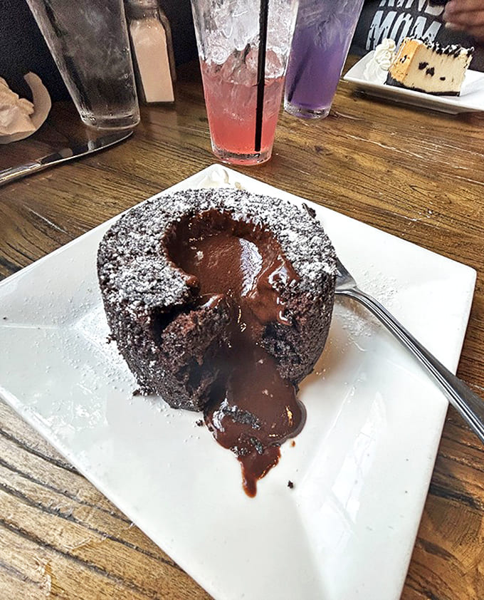 The chocolate lava cake's innocent exterior gives way to molten decadence &ndash; a dessert that silences conversation and replaces words with appreciative moans.